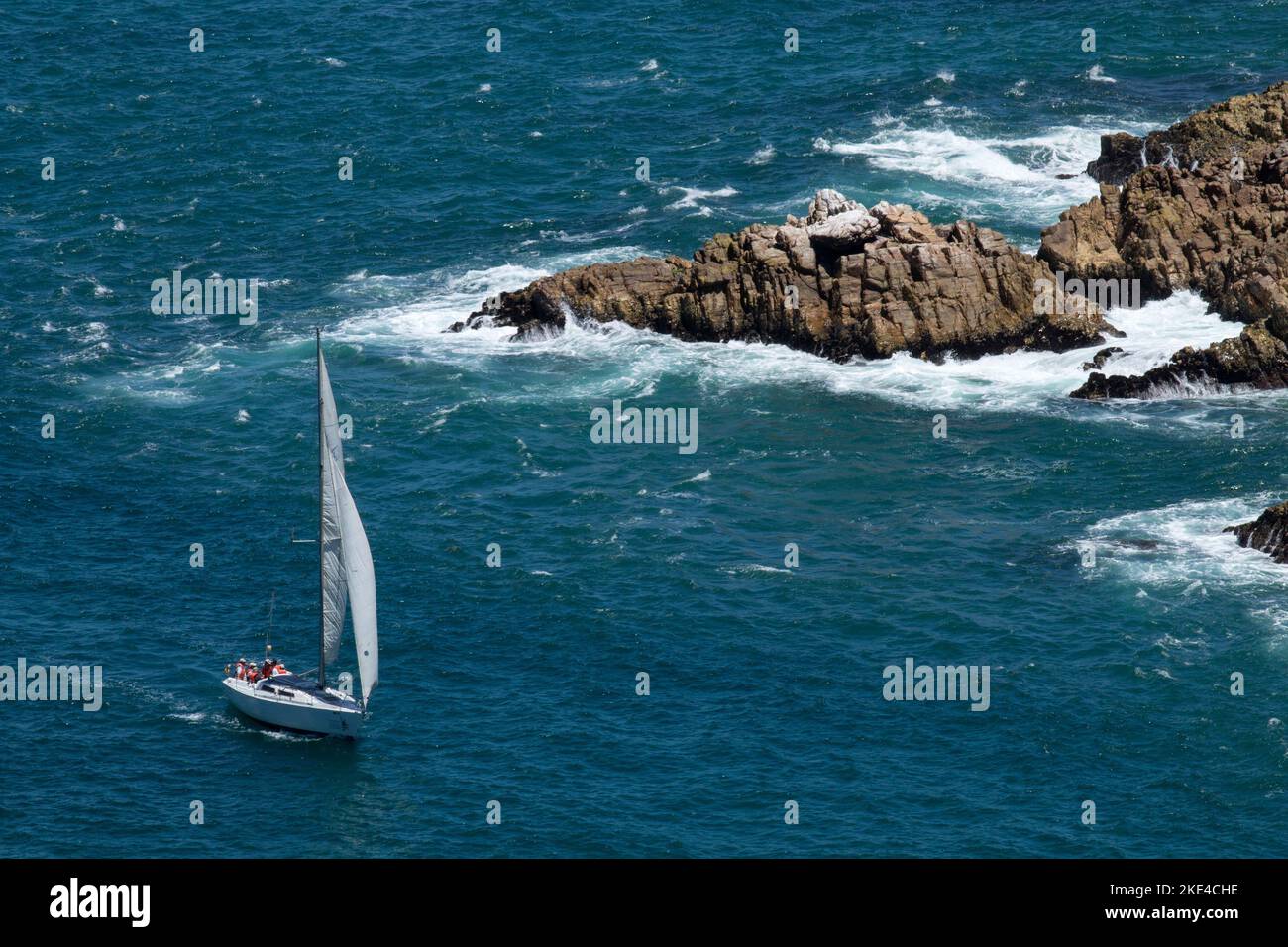 A Sailboat sailing through the Knysna Heads in the Western Cape of ...