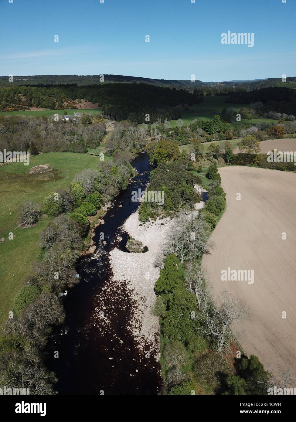 An aerial view of a river with rocks on a sunny day Stock Photo - Alamy