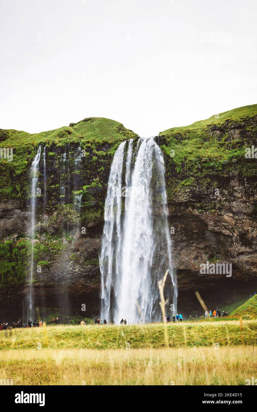 Crowds of tourists at the Seljalandsfoss, Gljufrabui waterfall Stock ...