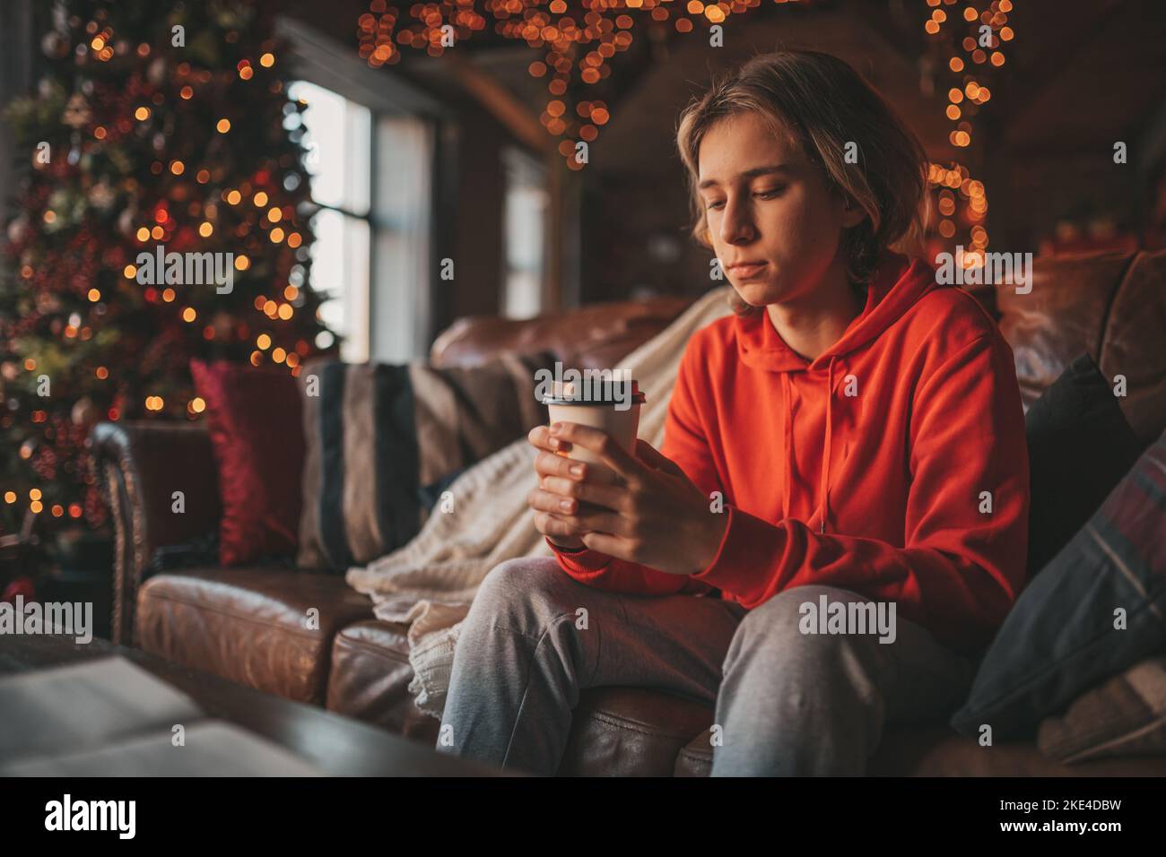 Young teen boy with long hair thoughtful look sad eyes negative mood ...