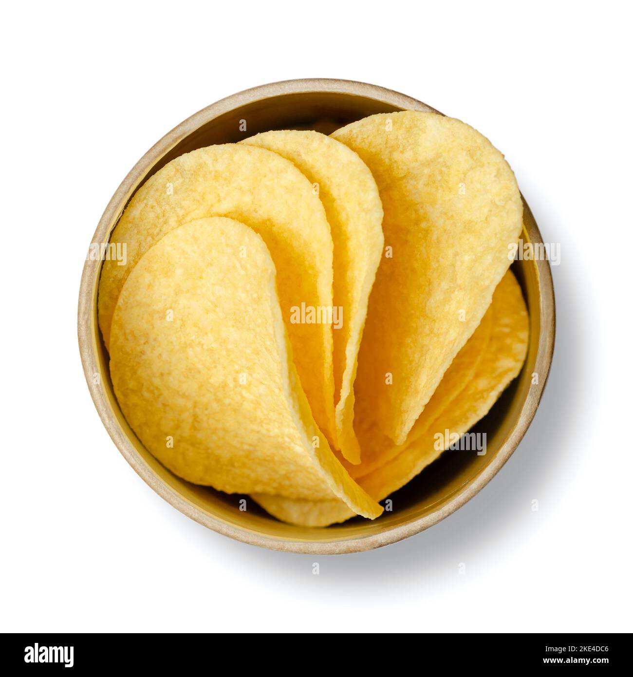 Salted potato chips, in an opened cardboard can, from above. Thin ...