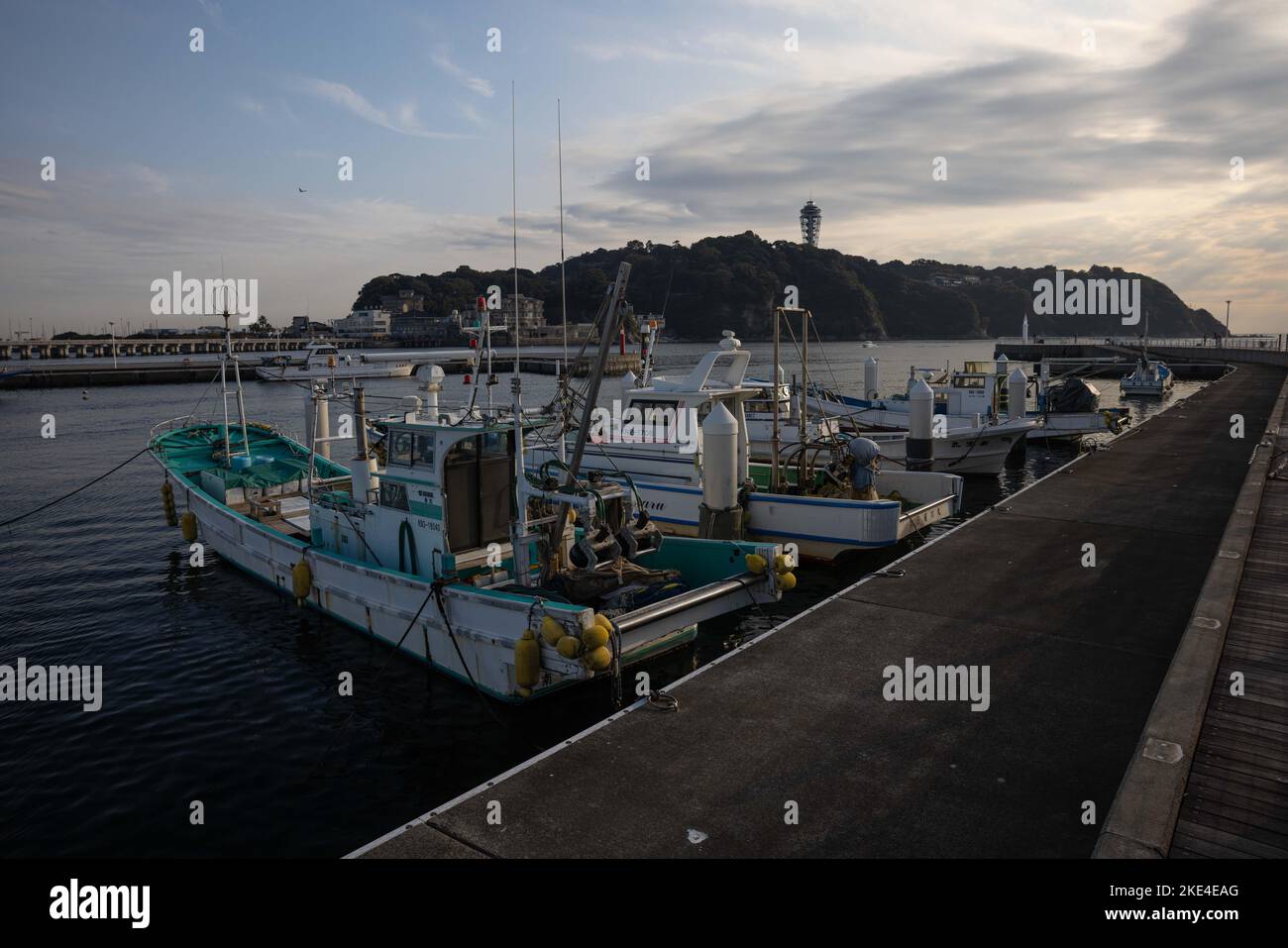 Fishing boats anchored inside Enoshima marina. Enoshima beach is a ...