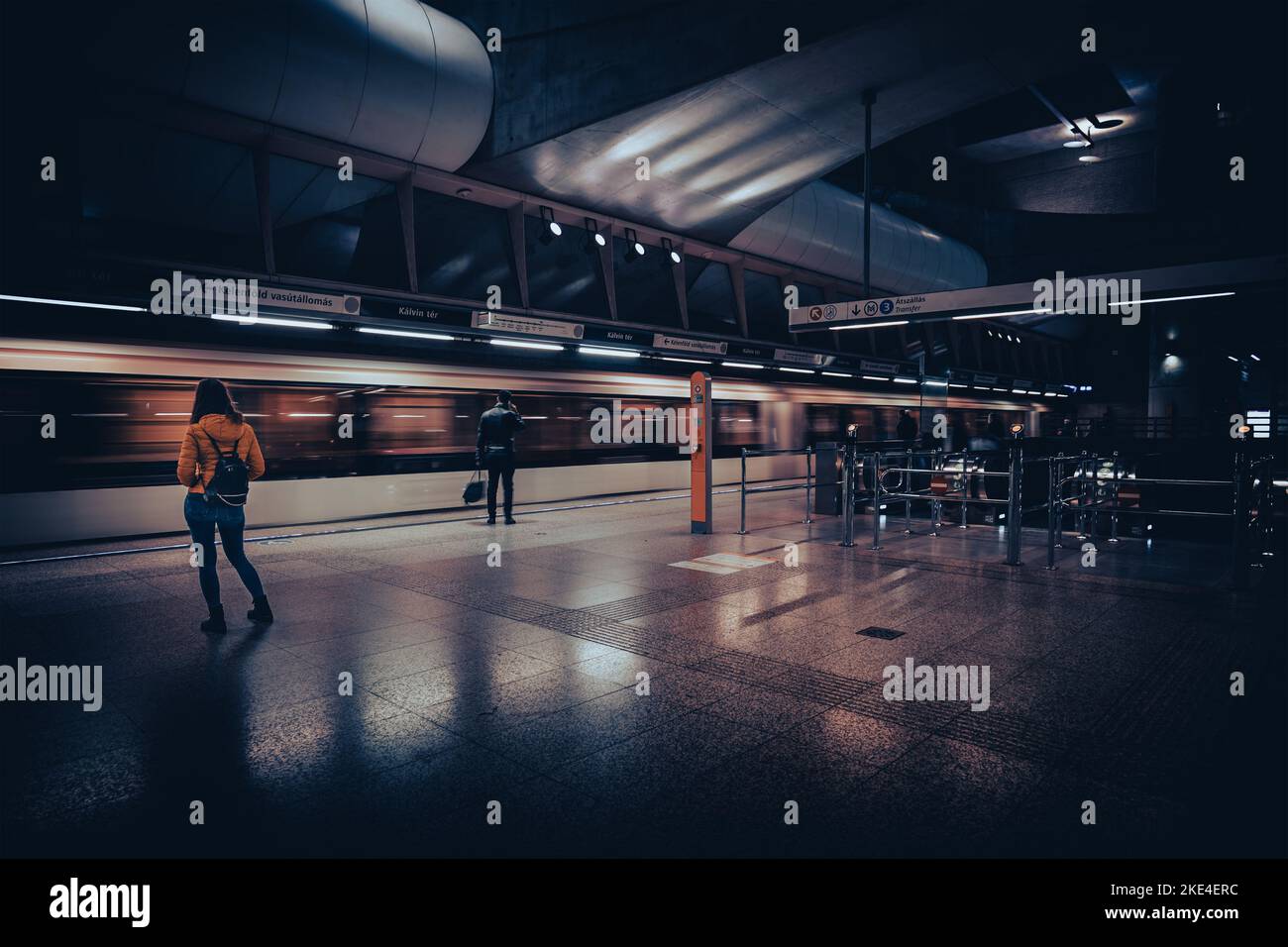 A dramatic long exposure shot of people waiting for a train in the underground station Stock ...