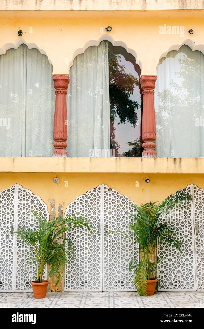 yellow windows with flowers in india Stock Photo - Alamy