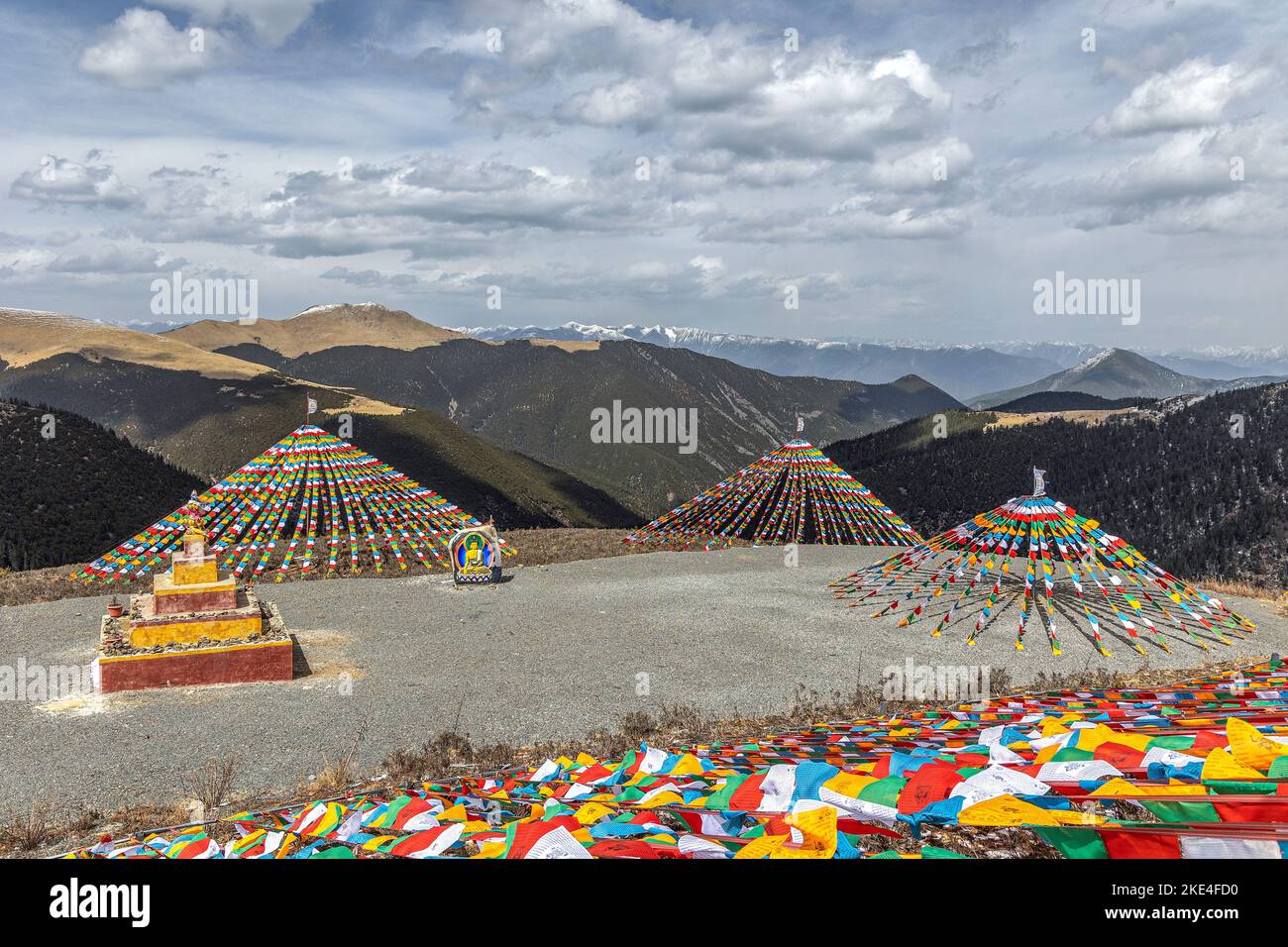 A string of colorful Tibetan prayer flags in pyramid form surrounded by ...