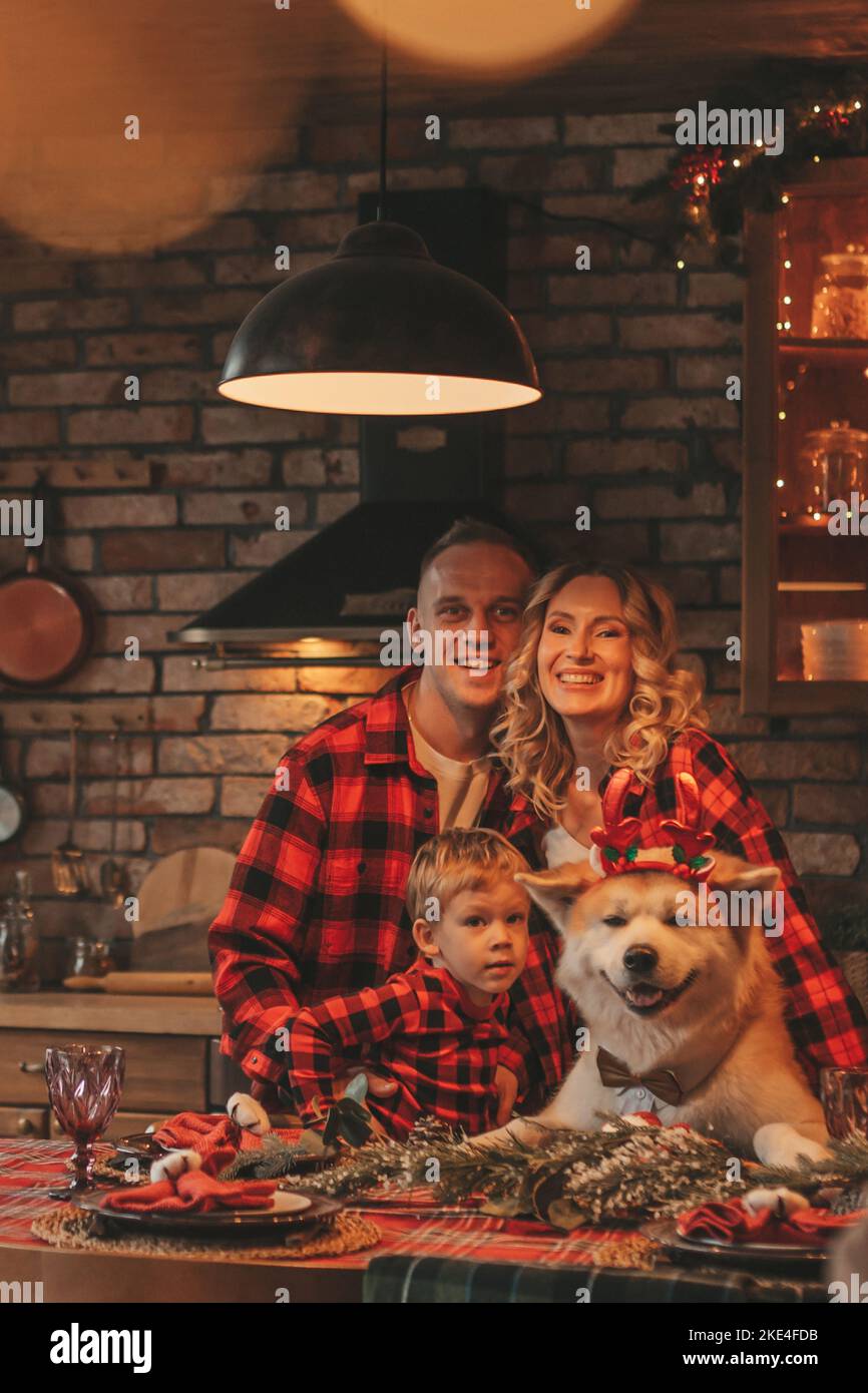 Portrait of happy family with son in red plaid pajamas laughing hugs ...