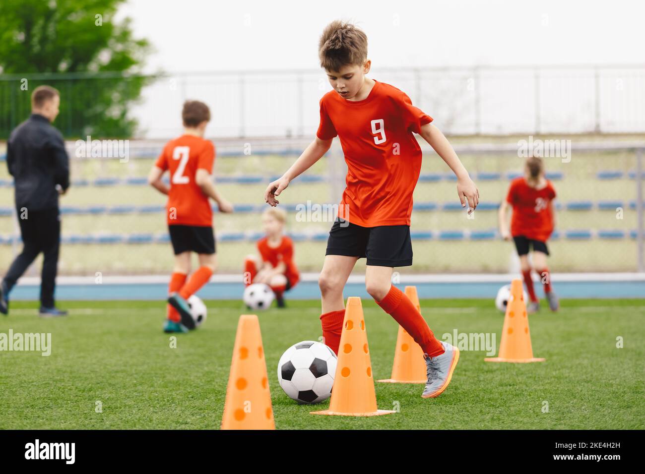 Young Boys on Football Practice Drill. Kids Running With Soccer Balls ...