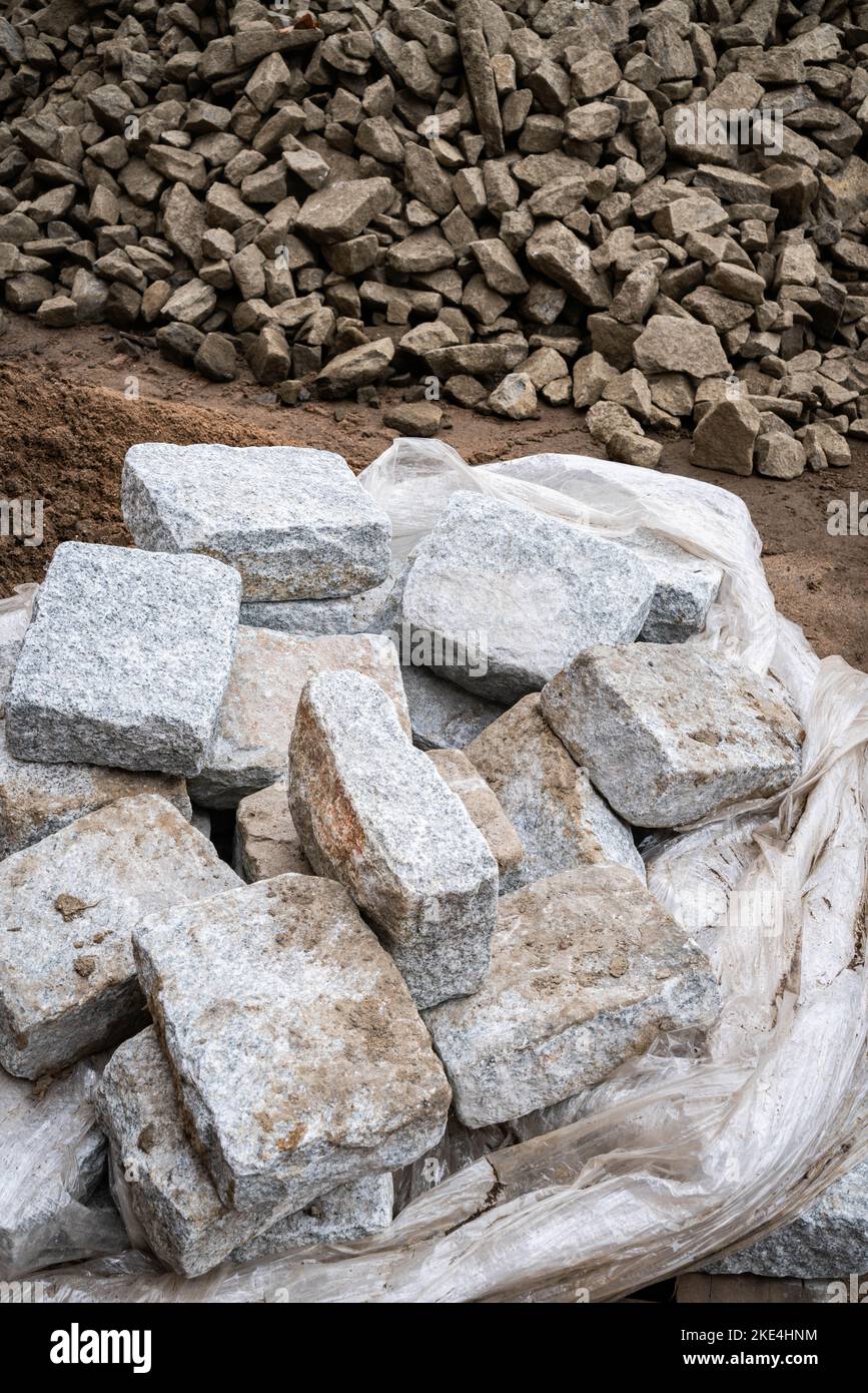 A pallet of Belgian blocks at a construction site with crushed rock in ...