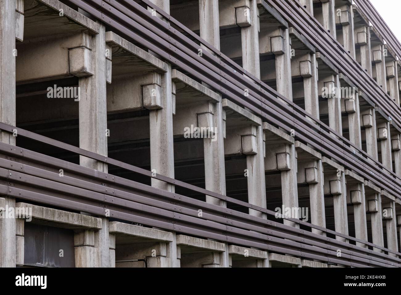 A side shot of a big gray building with pattern columns and line ...