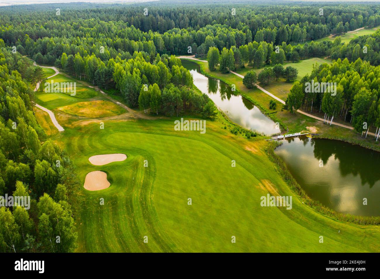 Top view of the golf course located in a wooded area Stock Photo - Alamy