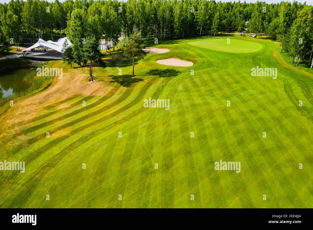 Top view of the golf course located in a wooded area Stock Photo - Alamy
