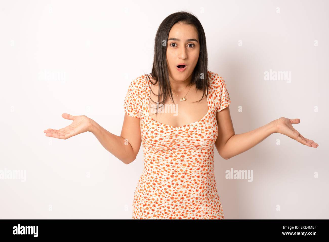 Image of excited brunette woman wearing casual polo shirt surprising ...