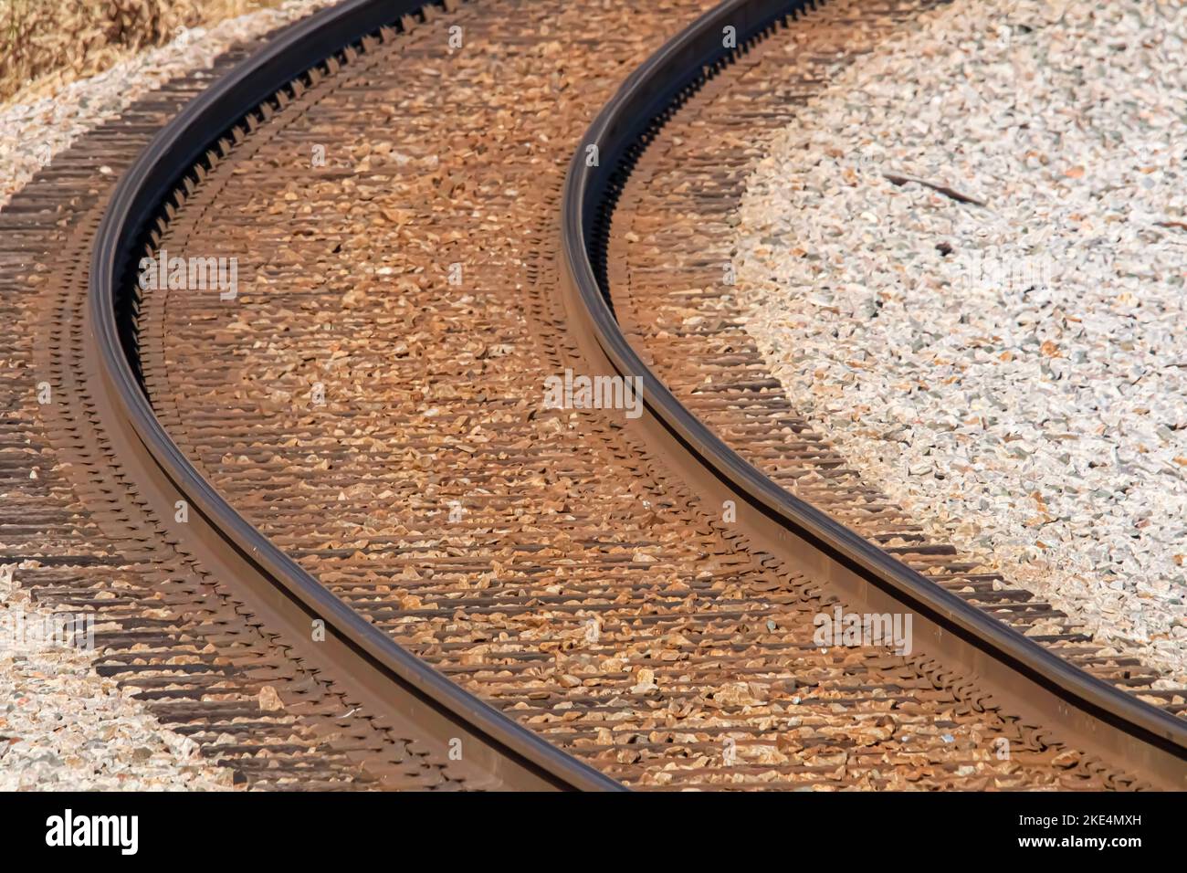 A rusty bend Railroad Track and gravel Stock Photo - Alamy