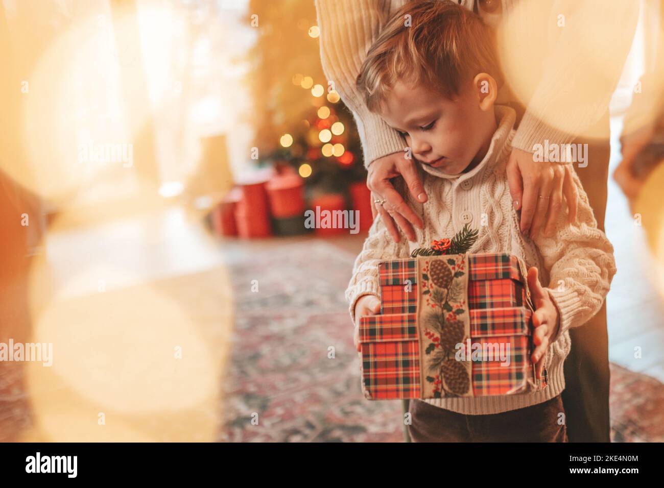 Portrait of happy family mom with small son in knitted beige sweaters ...