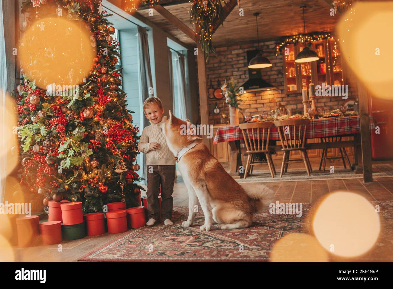Smiling small child having fun with dog waiting for miracle Santa at ...