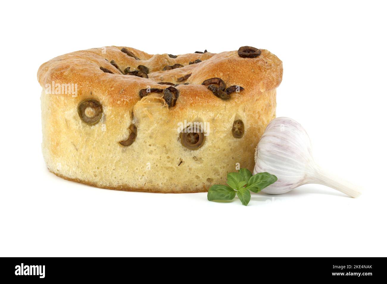 Round focaccia bread with olives, garlic and basil sprig isolated on ...