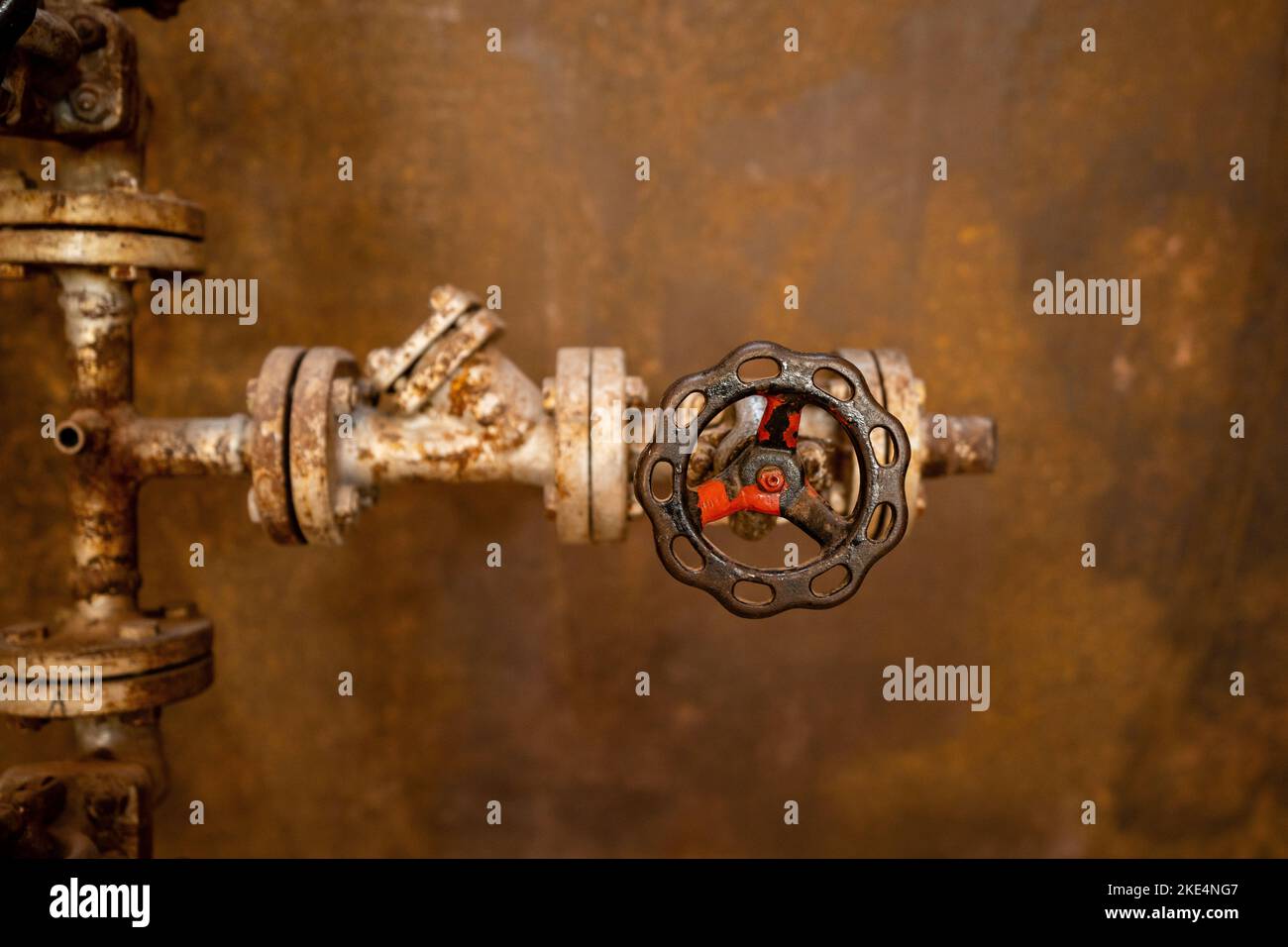 A closeup of a water valve handle on a rusty wall background Stock ...