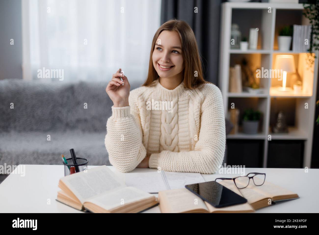 Dreamy student at home Stock Photo - Alamy