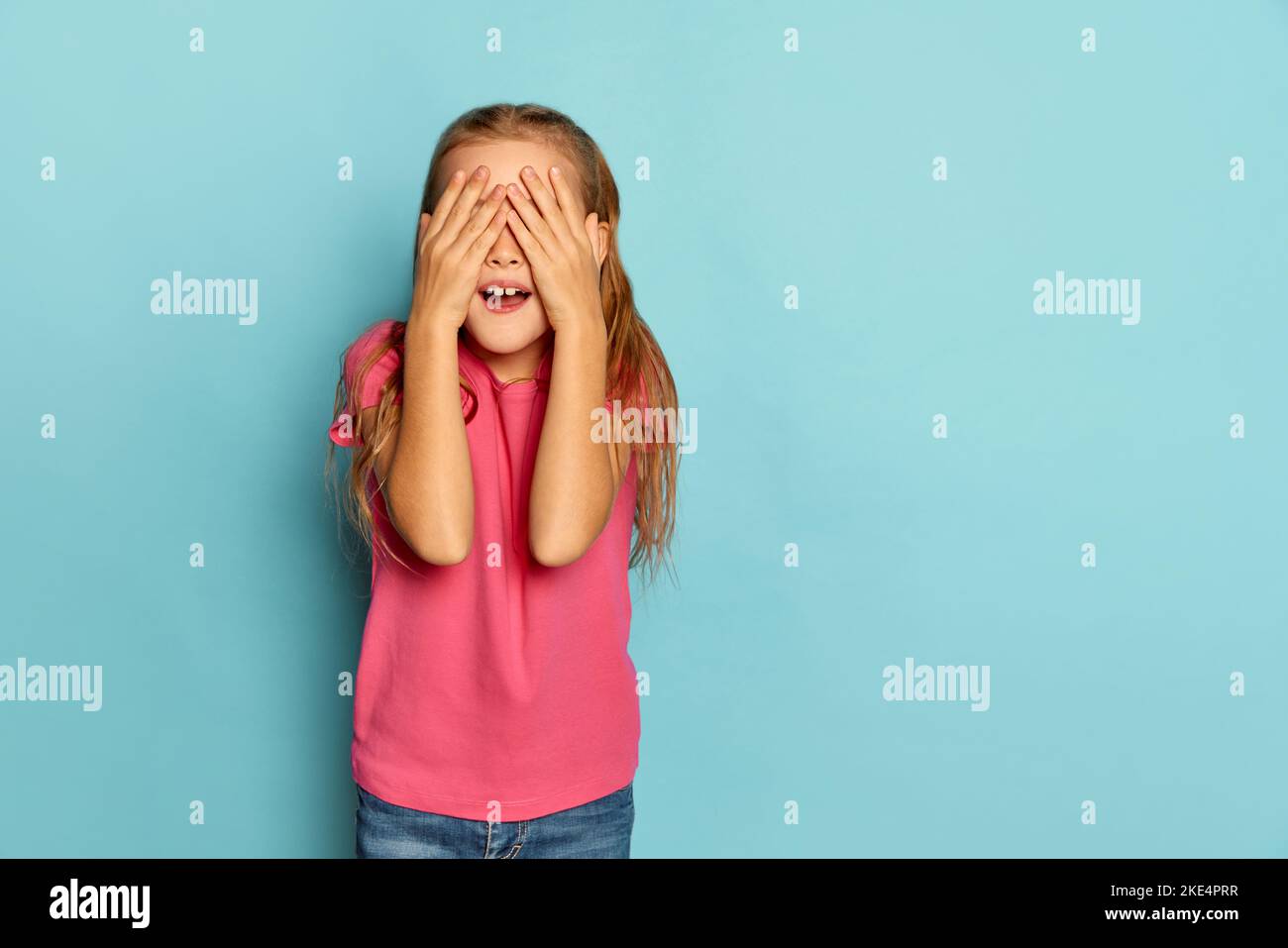 Portrait of little beautiful girl, child in pink T-shirt posing with ...