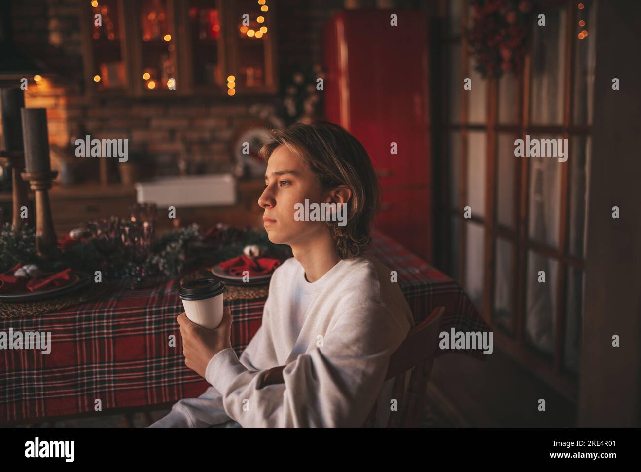 Young teen boy with long hair thoughtful look sad eyes negative mood ...