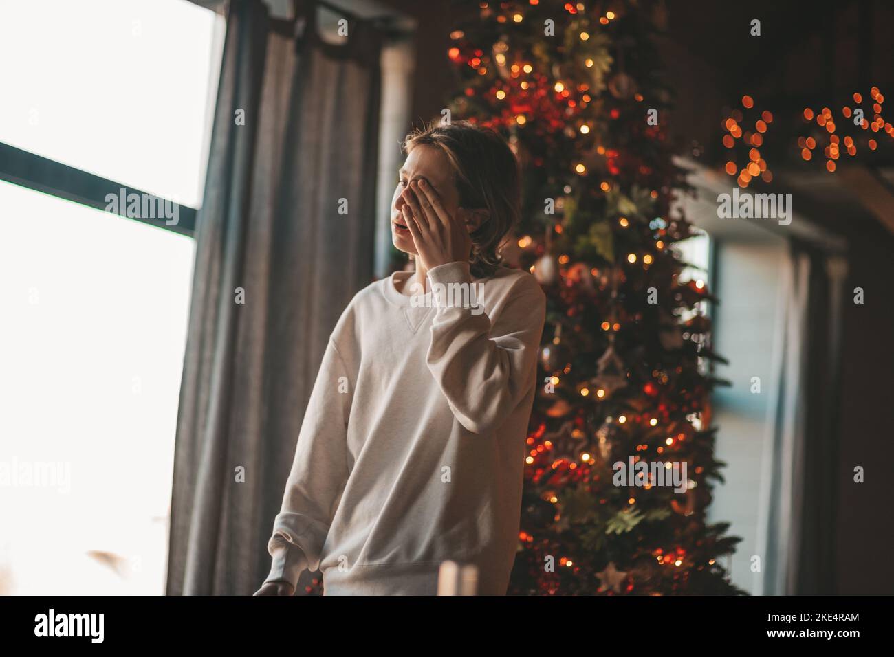 Young teen boy with long hair thoughtful look sad eyes negative mood ...