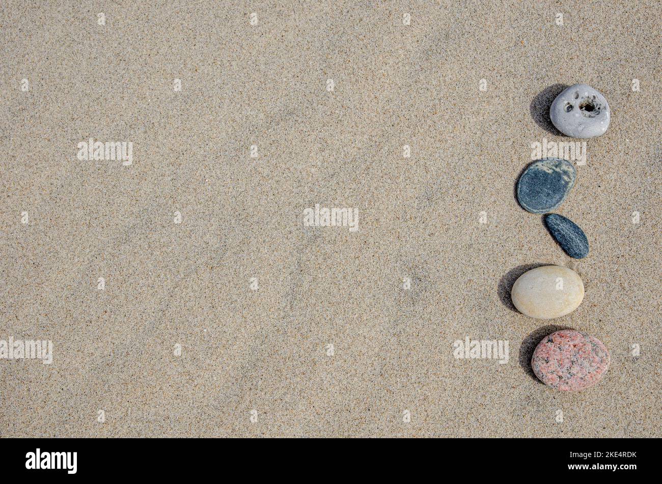 Top view of beach stones and pebbles lying on a sandy beach Stock Photo ...