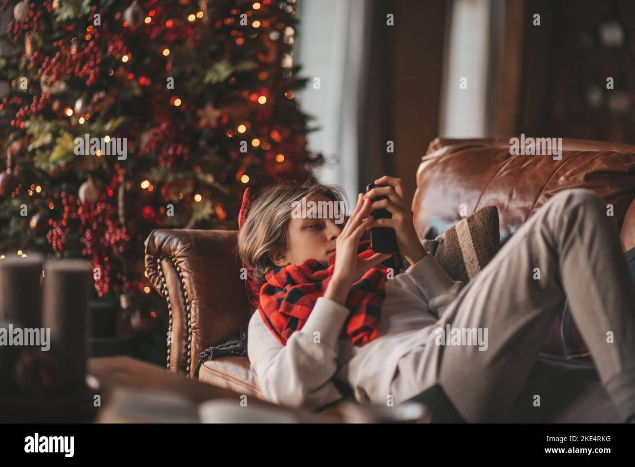 Young teen boy with long hair thoughtful look sad eyes negative mood ...