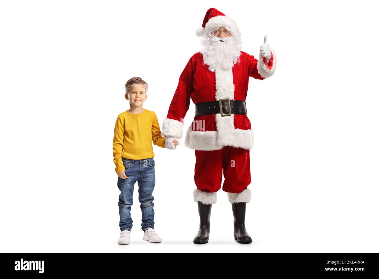 Full length portrait of santa claus gesturing thumbs up and holding ...