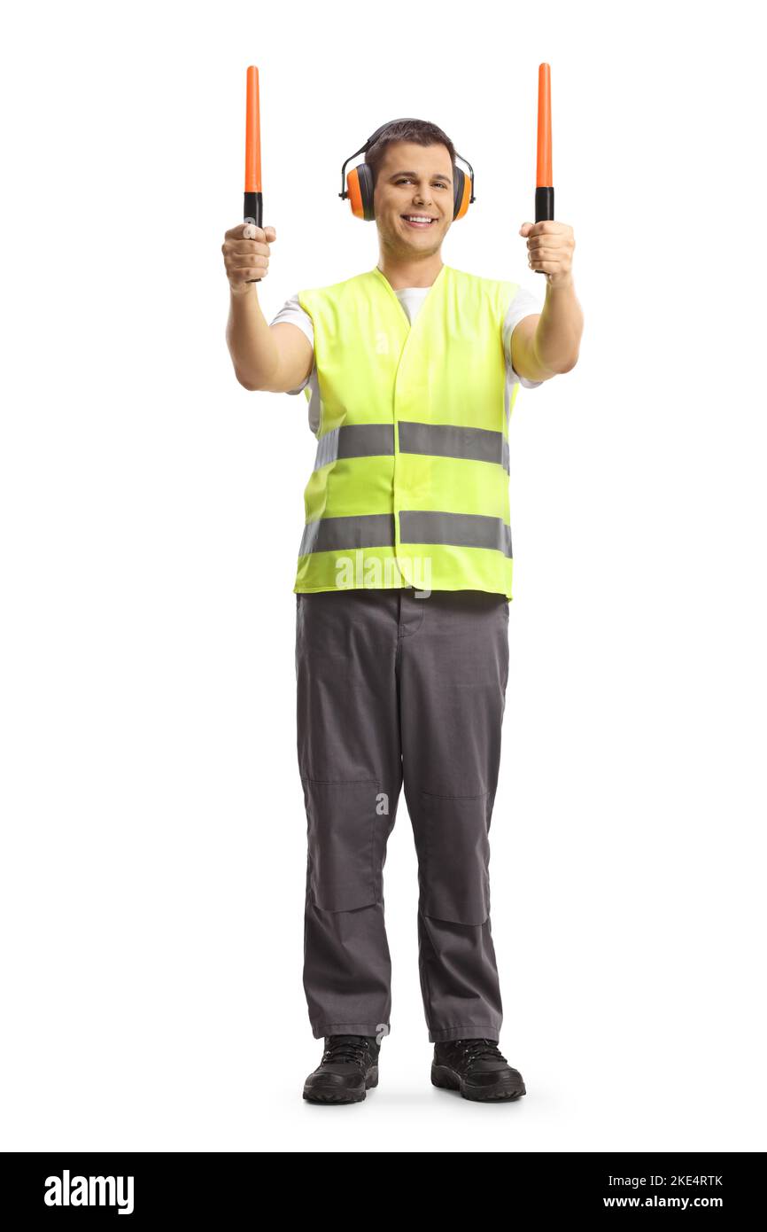 Full length pоrtrait of a male aircraft marshaller signalling with ...