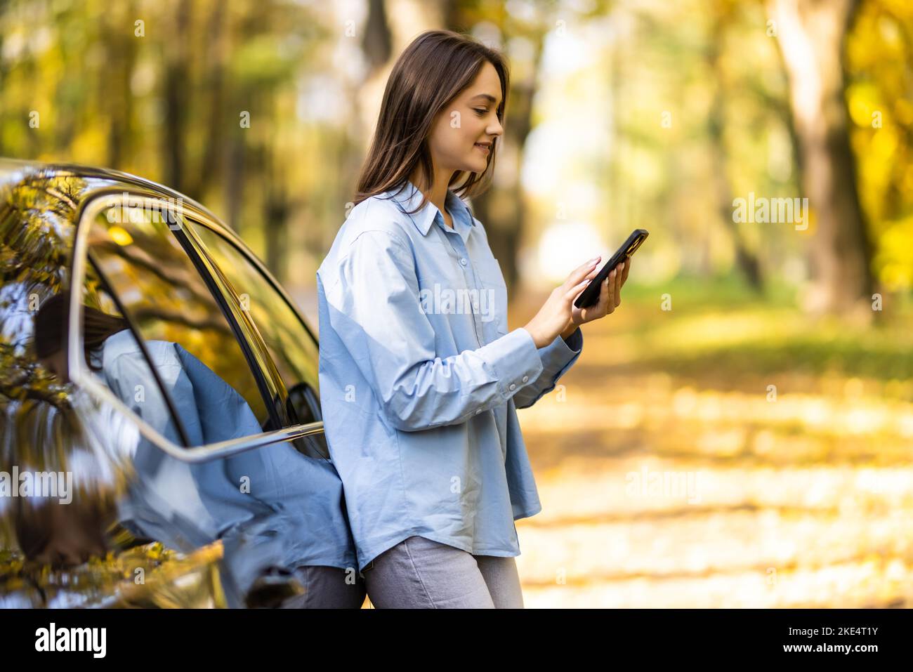 Successful smiling attractive woman in formal smart wear is using her ...