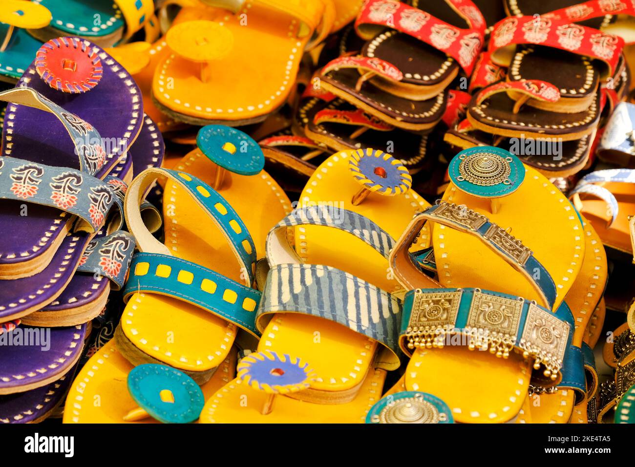 Colorful Handmade chappals (sandals) being sold in an Indian market ...