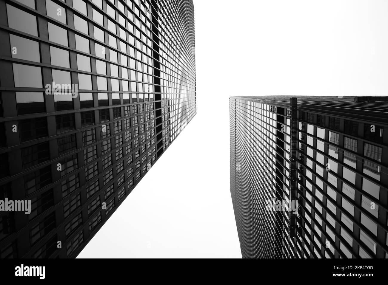 A grayscale shot of office buildings with a white sky background Stock ...