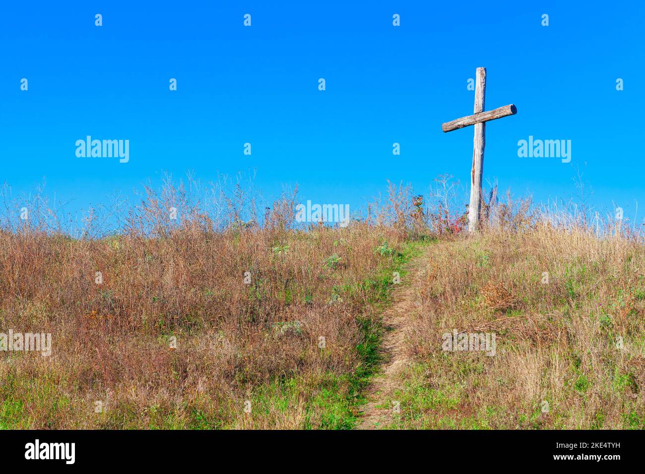 Wooden cross on the hill . Way to the religion Stock Photo - Alamy