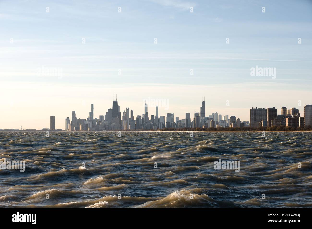 A breathtaking view of a Chicago Skyline, over the wavy Michigan lake ...