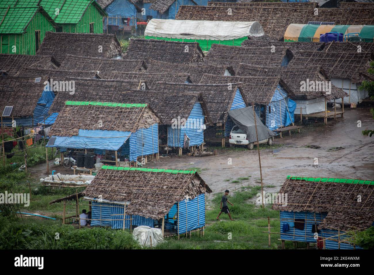 A Karen refugee walks through a temporary Karen refugee camp on the ...