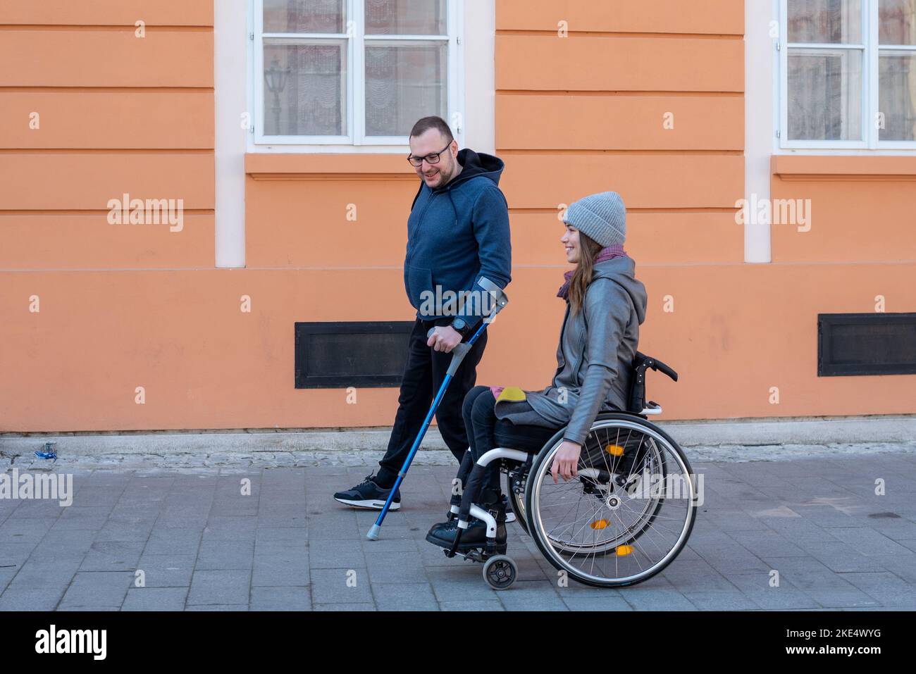 Friends with a disability. Woman who uses a wheelchair and man with a ...
