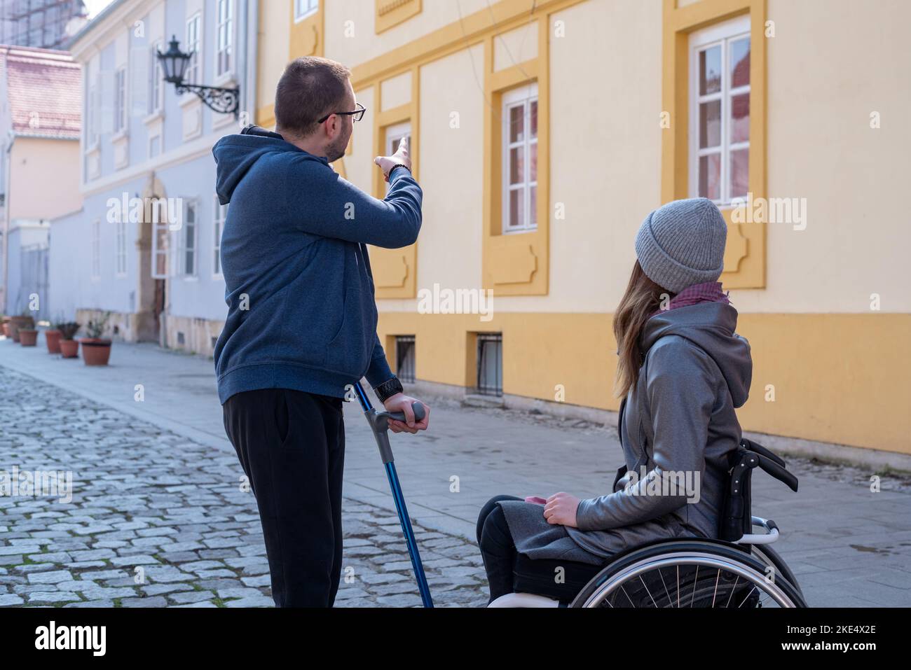 Friends with a disability. Woman who uses a wheelchair and man with a ...