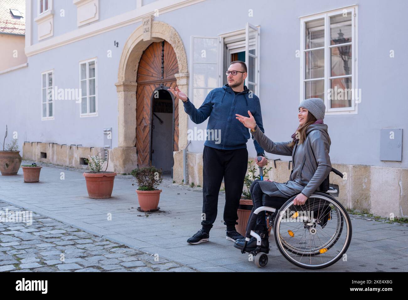 Friends with a disability. Woman who uses a wheelchair and man with a ...