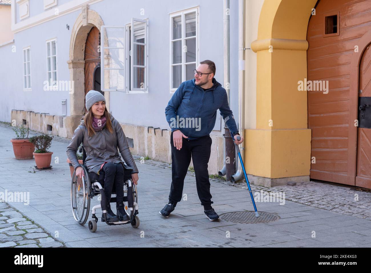 Friends with a disability. Woman who uses a wheelchair and man with a ...