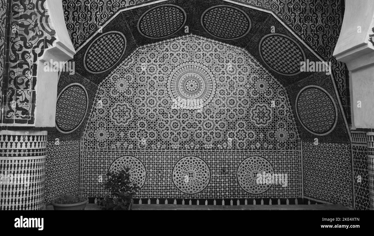 A grayscale of a unique tiled water fountain with decorative ...