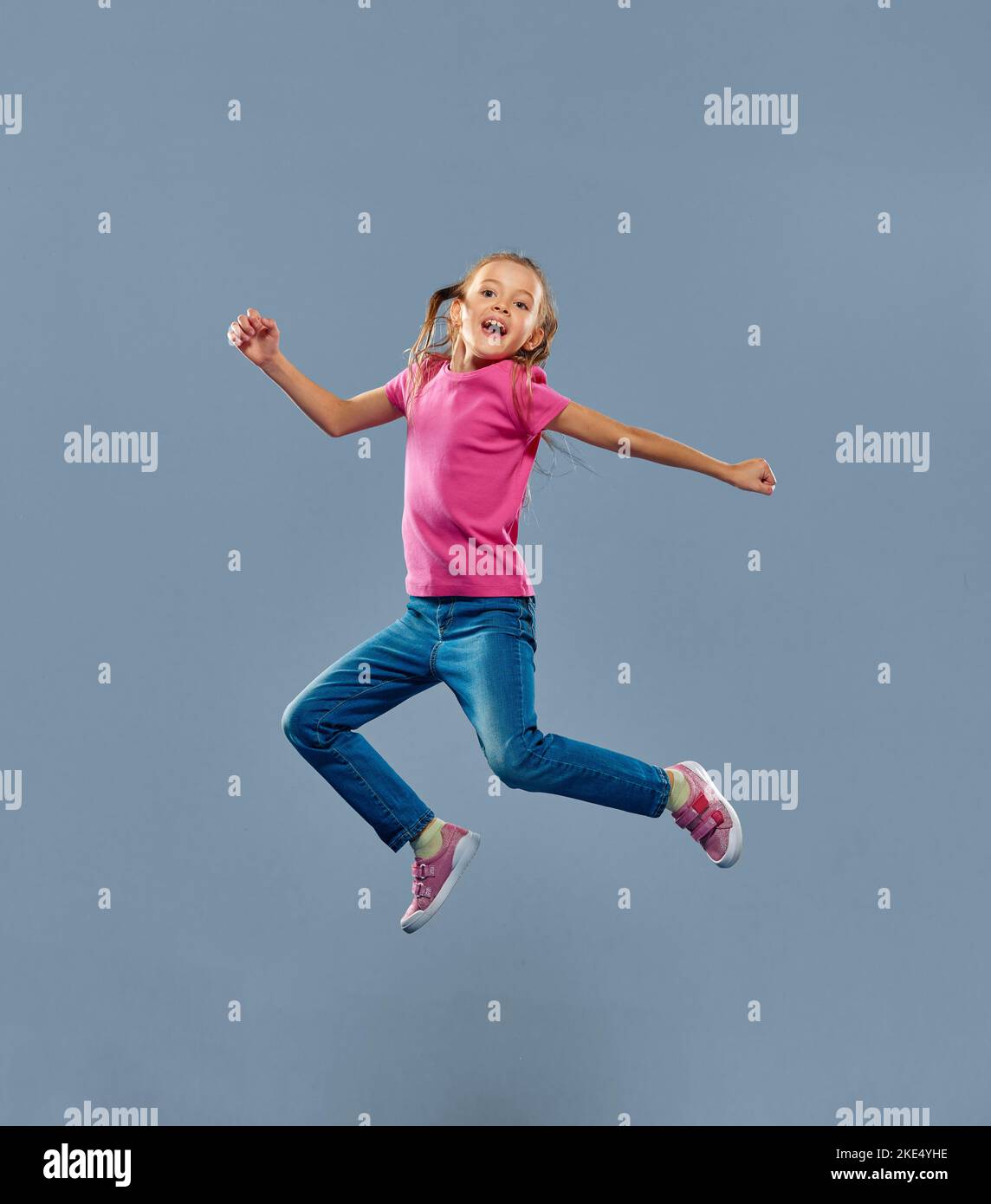 Portrait of little beautiful girl, child in casual clothing posing ...