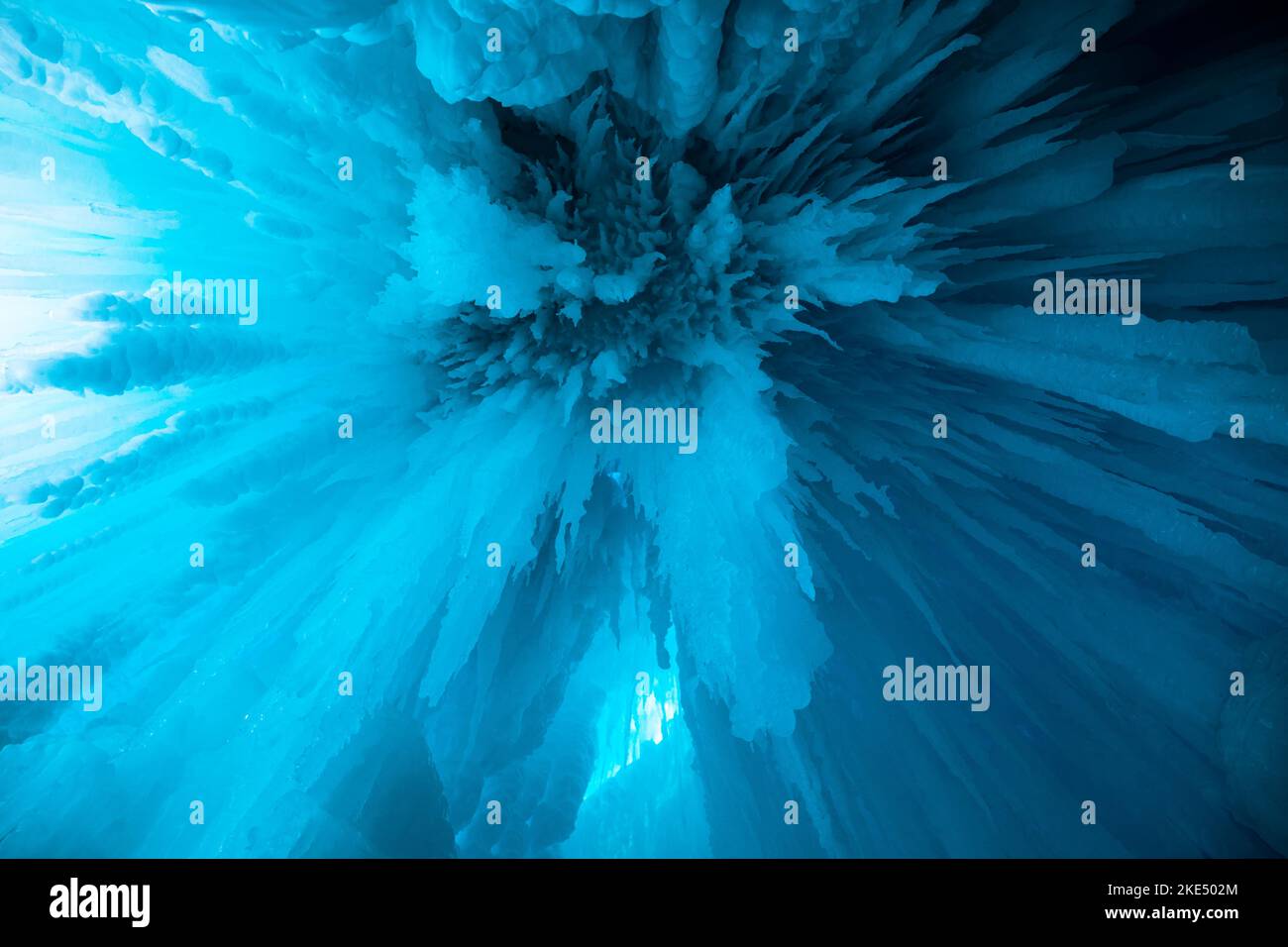 A low angle of an ice formation with hanging huge blue icicles Stock ...