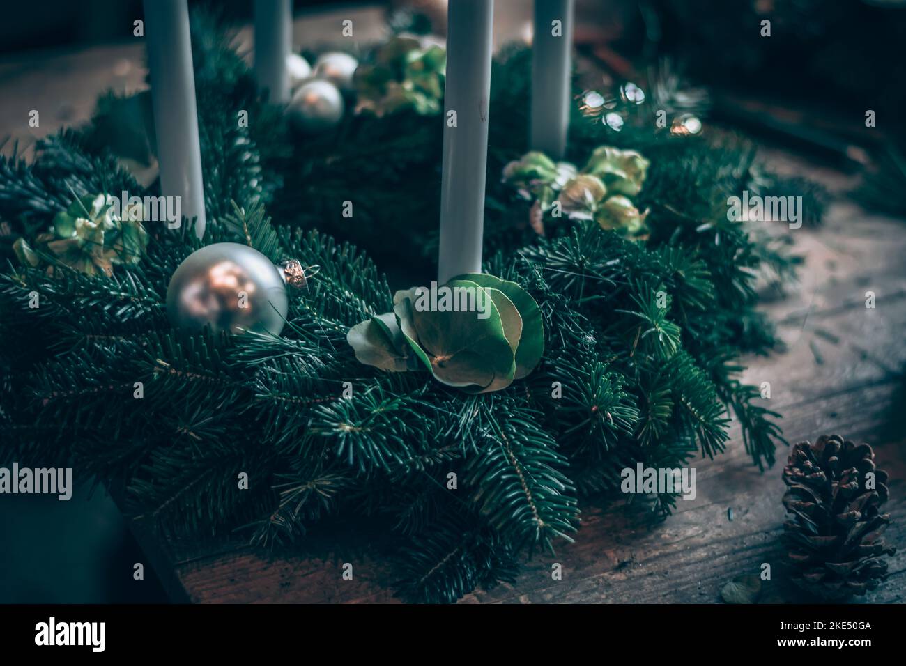 christmas baubles, burning candle and green pine fir prepared for ...