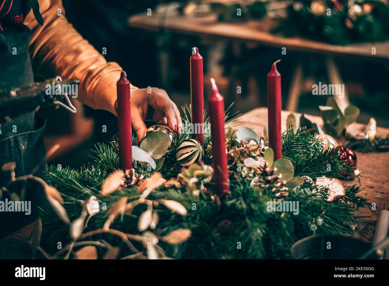 christmas baubles, burning candle and green pine fir prepared for ...
