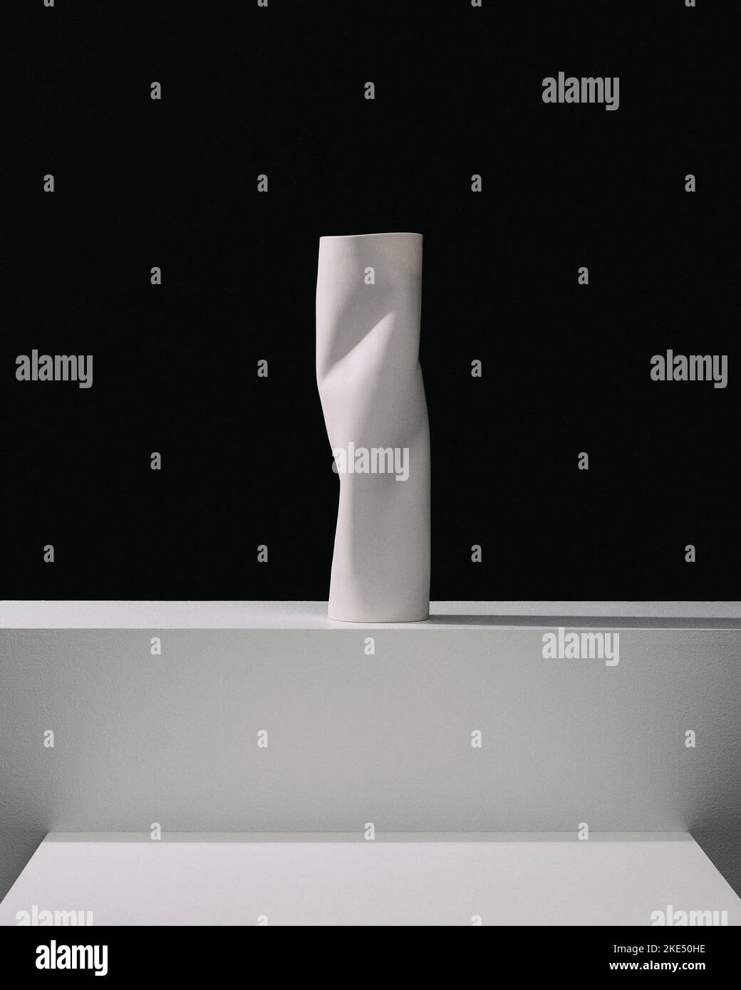 A vertical shot of ceramic vase in a studio on isolated black ...