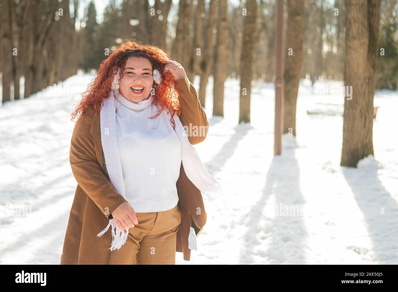 Cheerful fat caucasian woman walks in the park in winter Stock Photo ...