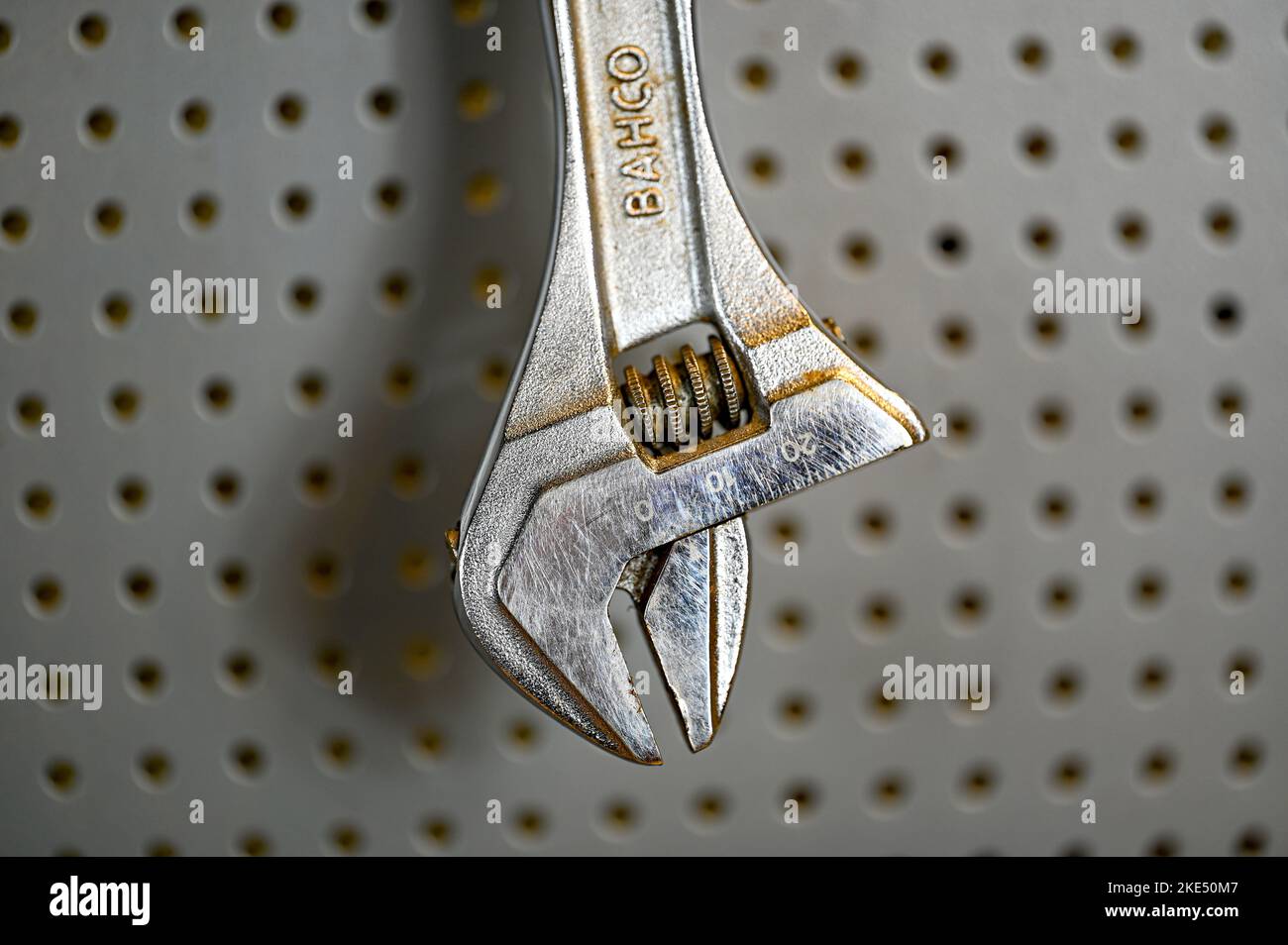 silver colored spanner hanging on tool board Stock Photo - Alamy