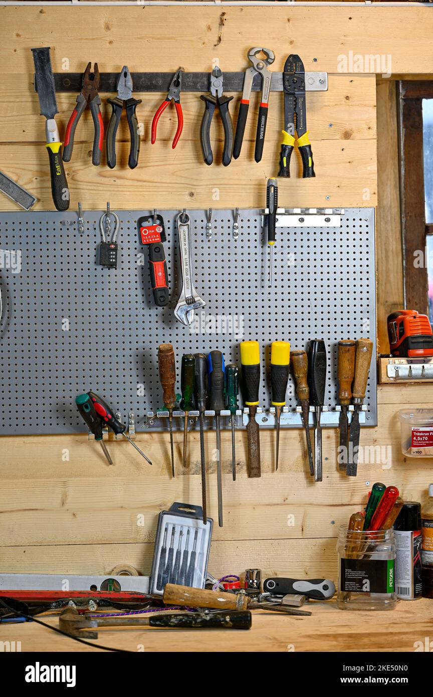 tools hanging on wall in workshop at home Stock Photo - Alamy