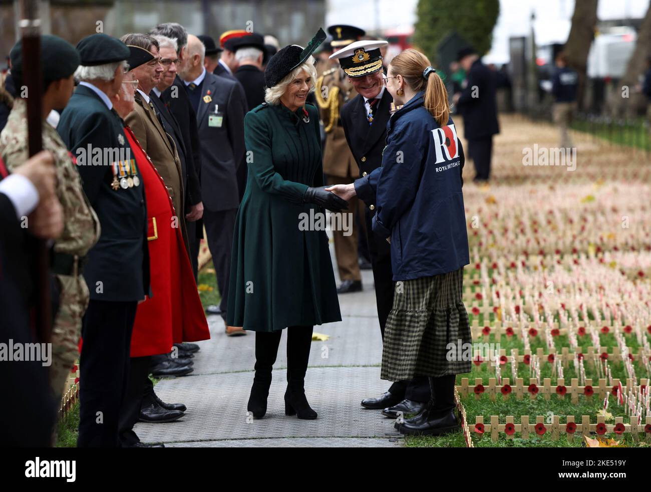 The Queen Consort, Patron of the Poppy Factory, as she greets a woman ...