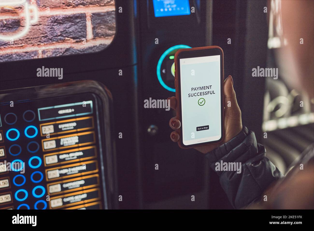 Consumer paying for product at vending machine using contactless method ...